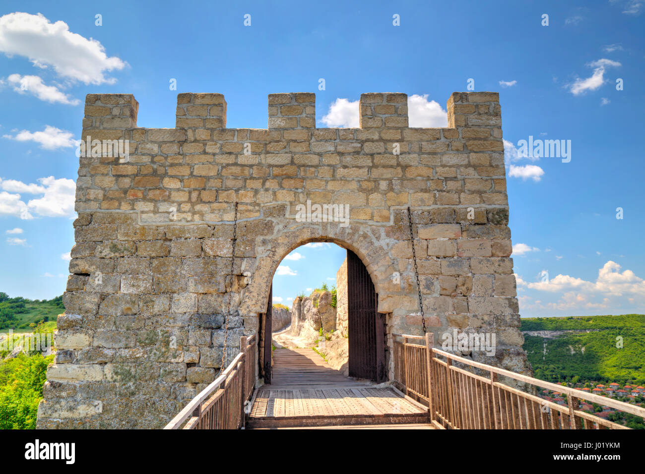 Stone walls and gate with wooden bridge of medieval fortress Stock ...