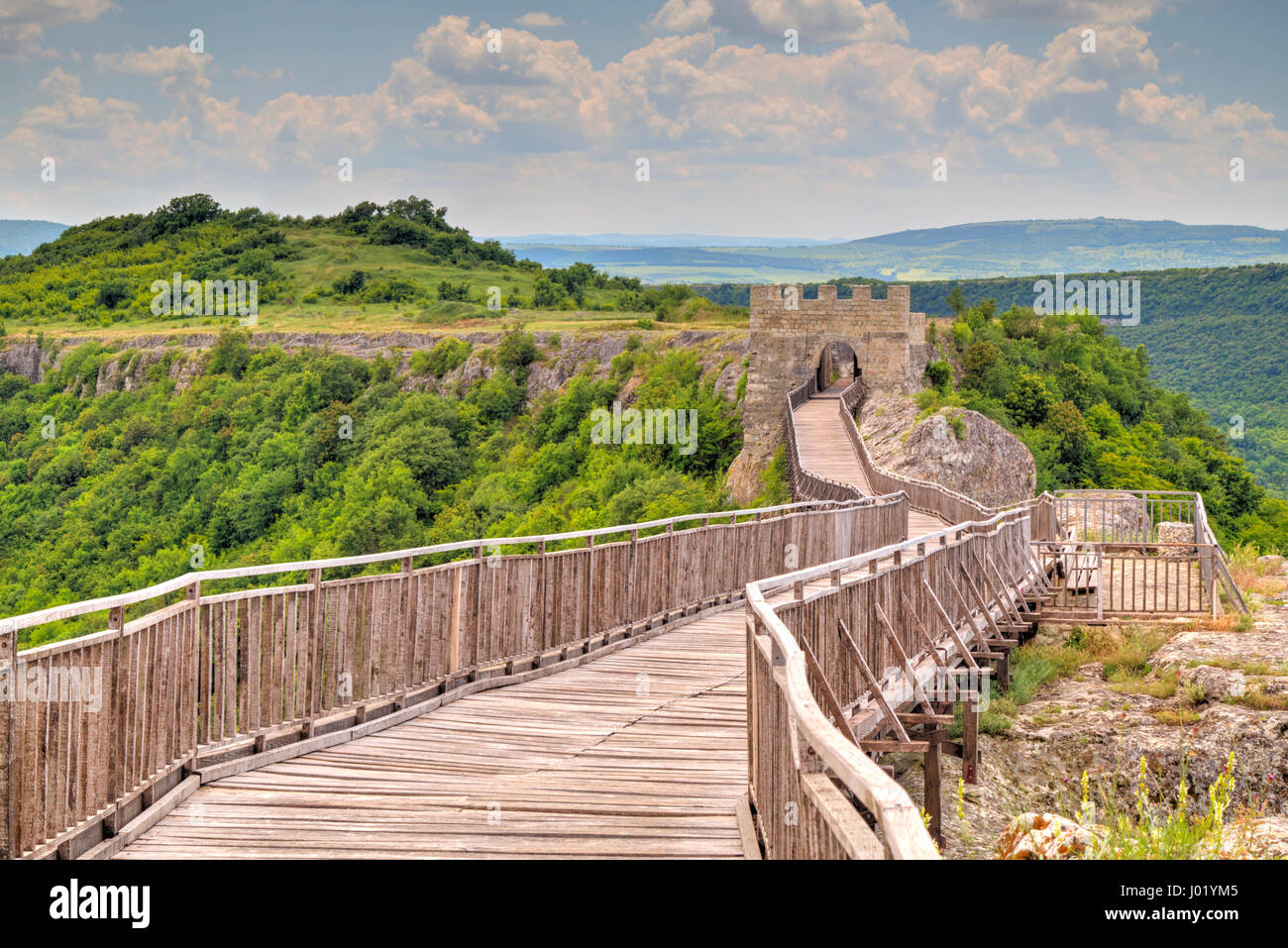 Stone walls and gate with wooden bridge of medieval fortress Stock ...