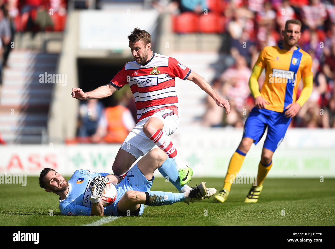 Doncaster Rovers Andy Williams (right) is challenged by Mansfield Town ...