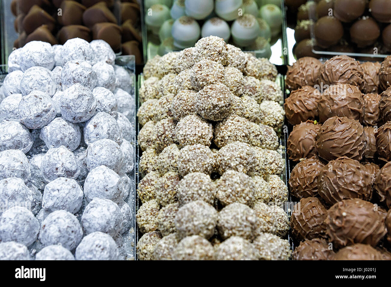Selection of milk and white Swiss chocolate truffles Stock Photo - Alamy