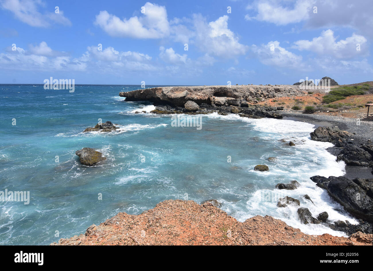 Pretty black sandstone beach on the Island of Aruba Stock Photo - Alamy