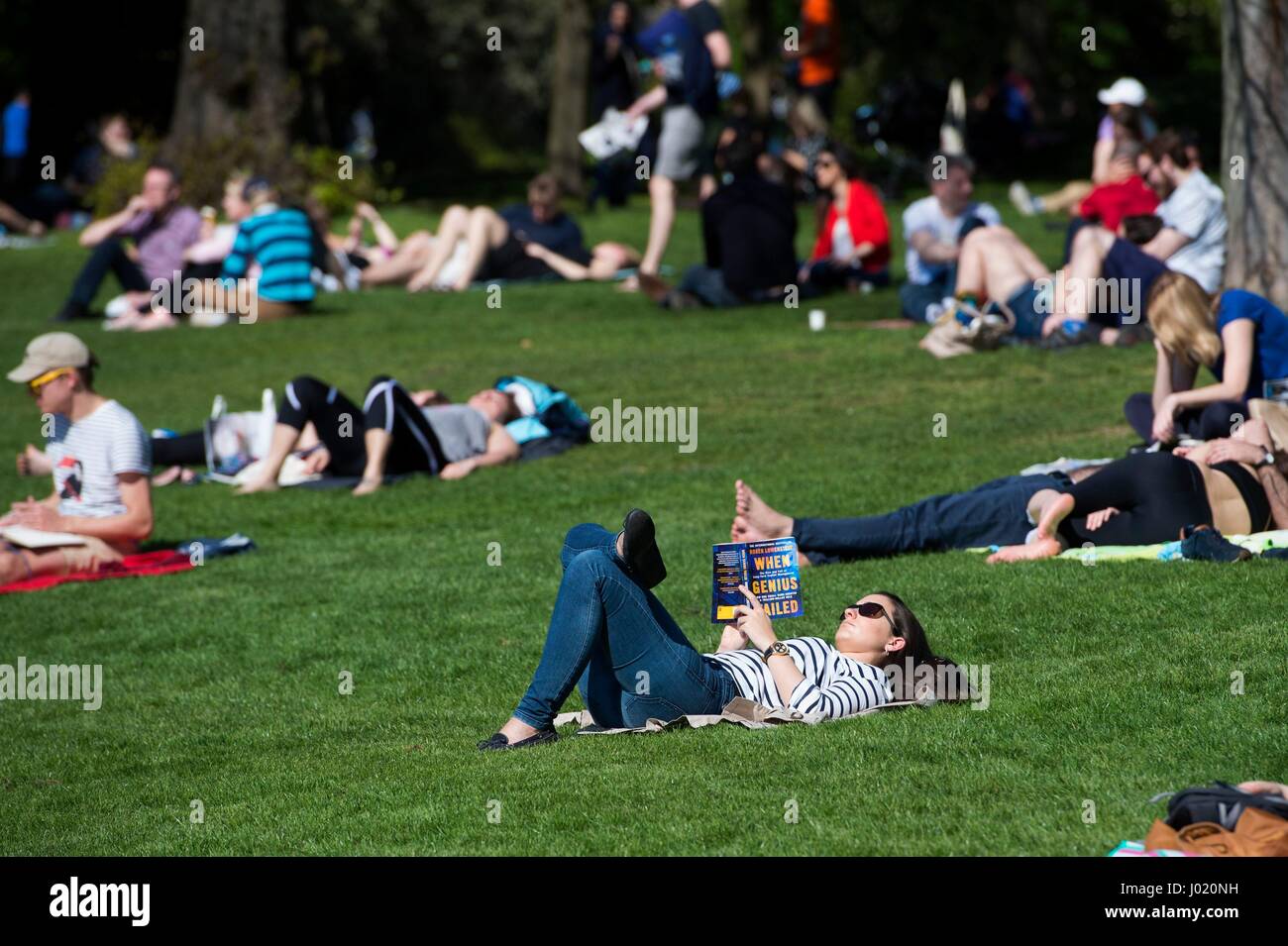 People sunbathe in Hyde Park, London, as Easter holiday temperatures ...
