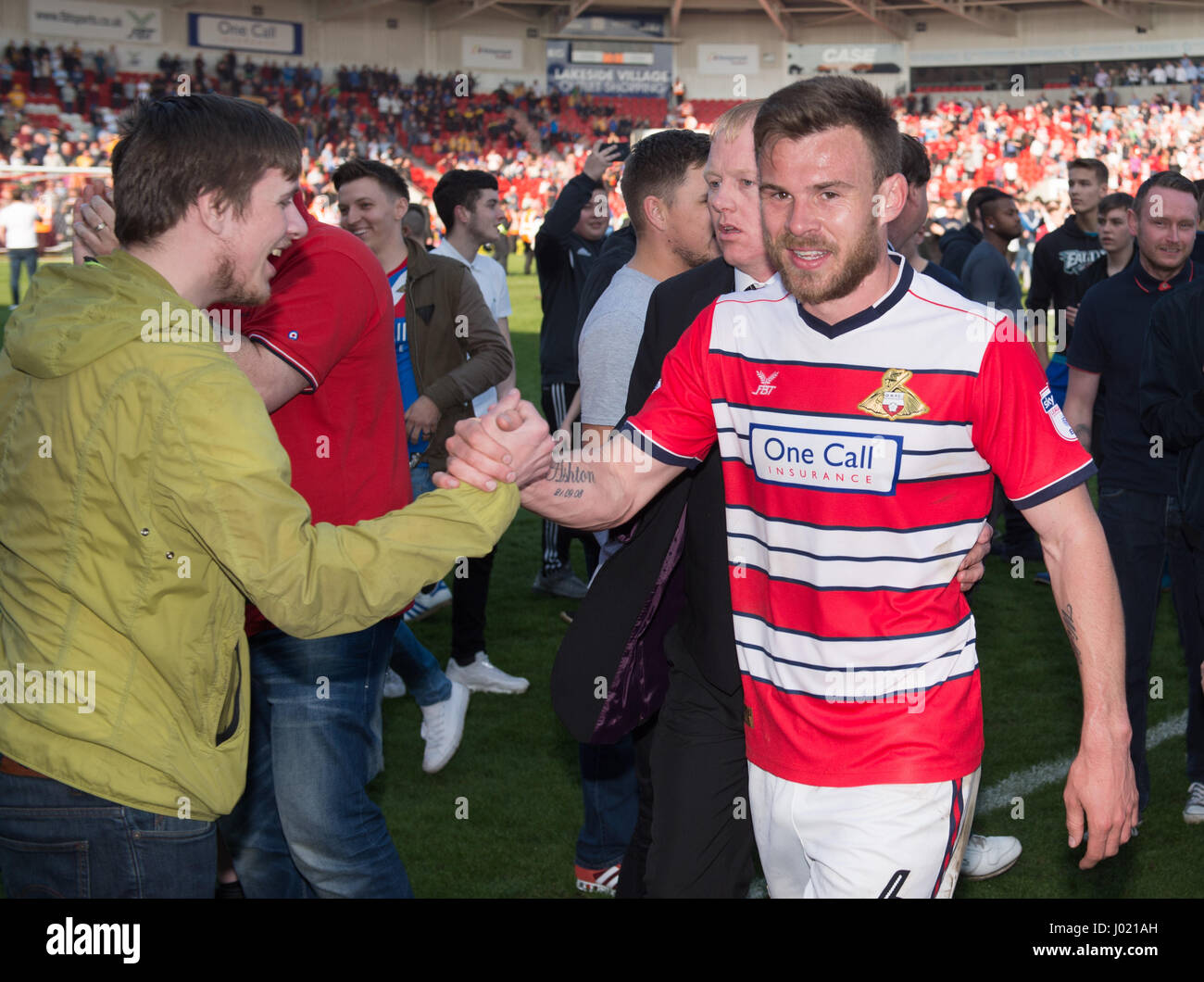 Doncaster Rovers Andy Butler celebrates promotion with the fans after ...