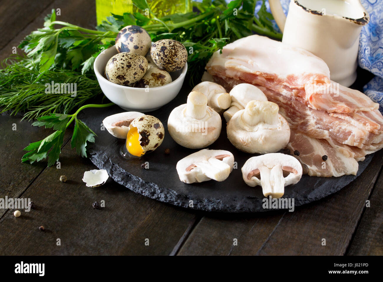 Background culinary - on a slate board mushrooms, ham, milk and quail ...