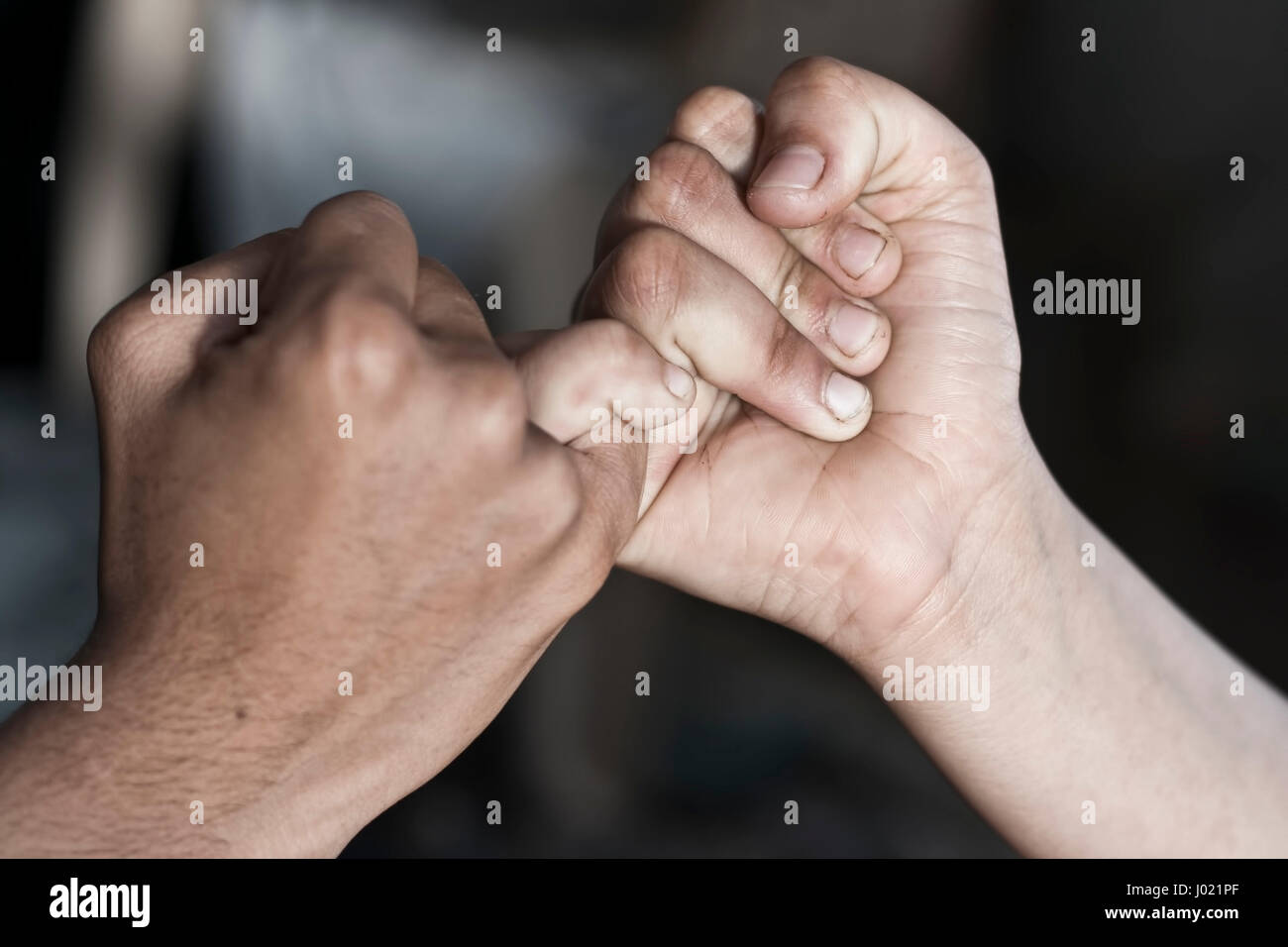 Two human fist in symbolic gesture of power Stock Photo - Alamy