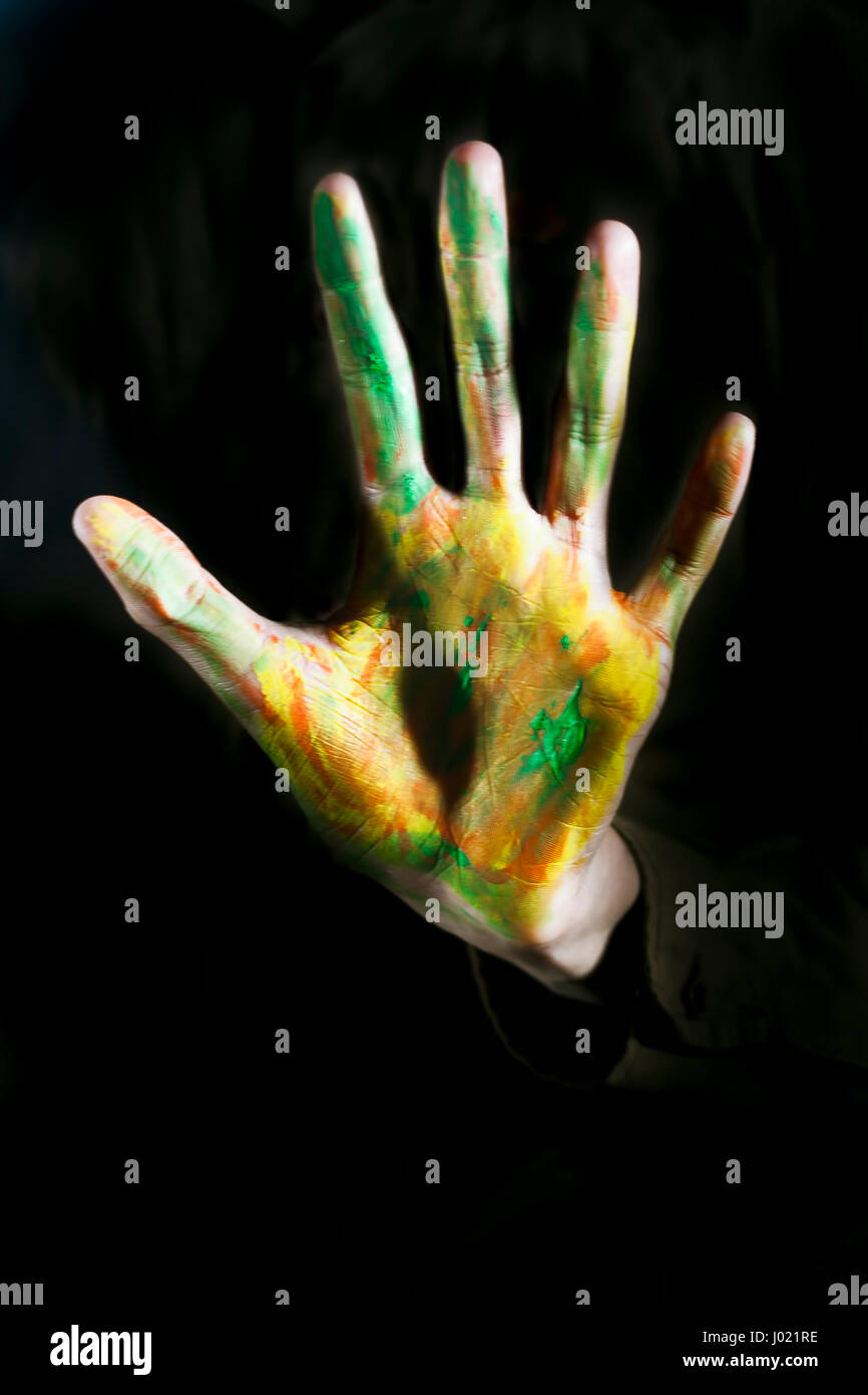 Human hands painted with poster color Stock Photo - Alamy
