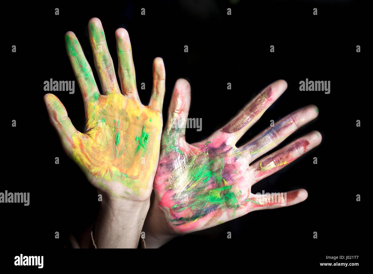 Human hands painted with poster color Stock Photo - Alamy