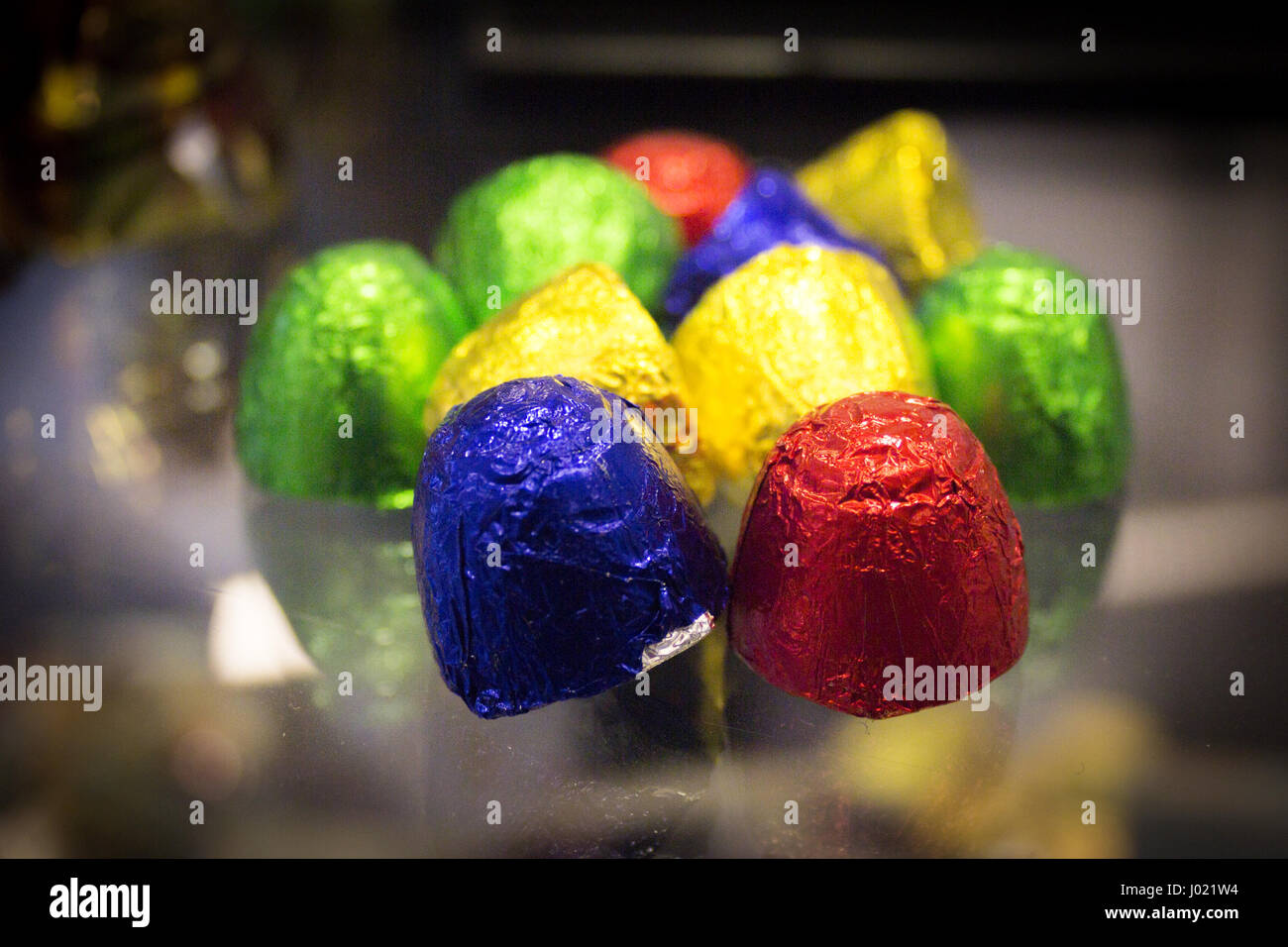 Small chocolates wrapped in metallic paper Stock Photo - Alamy