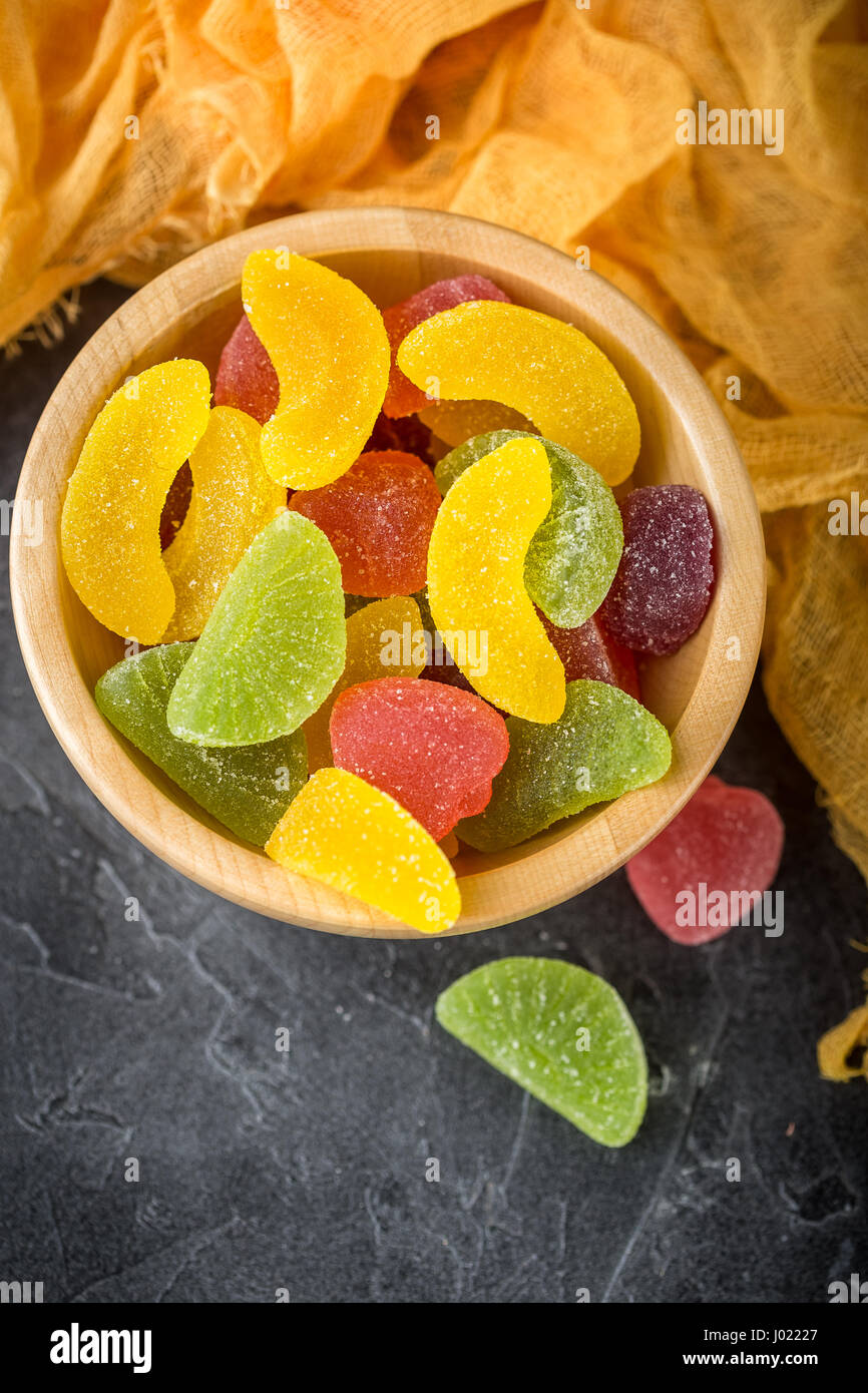 Multicolored candied fruit jelly in wooden bowl Stock Photo - Alamy