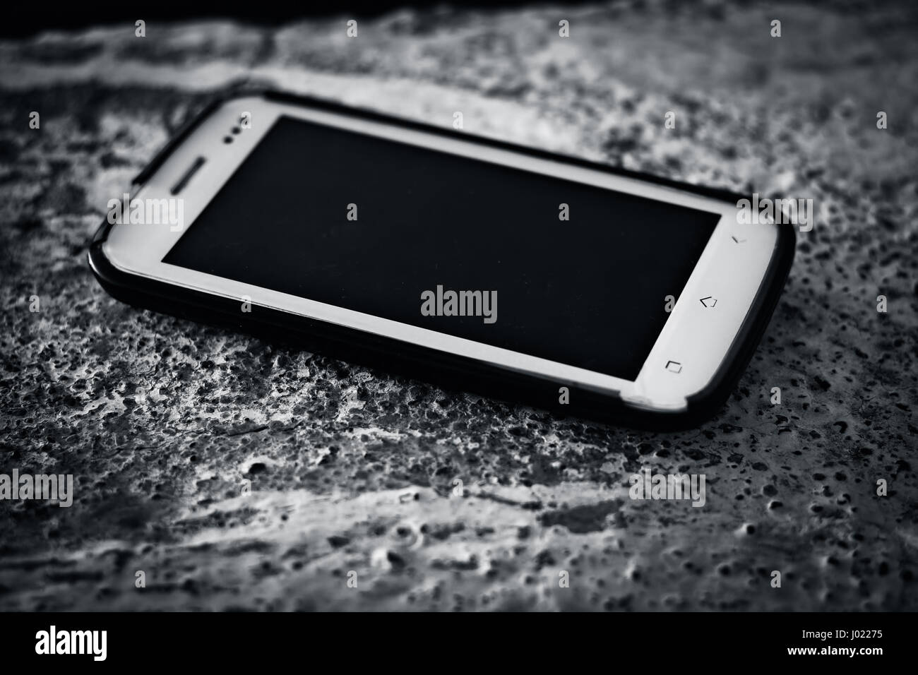 cell phone on the rough floor Stock Photo - Alamy