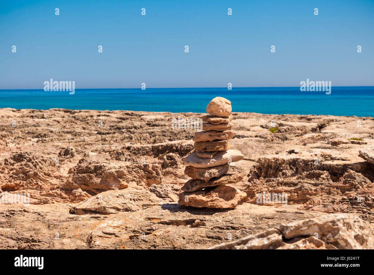 stack of stones on the beach and sea background Stock Photo - Alamy