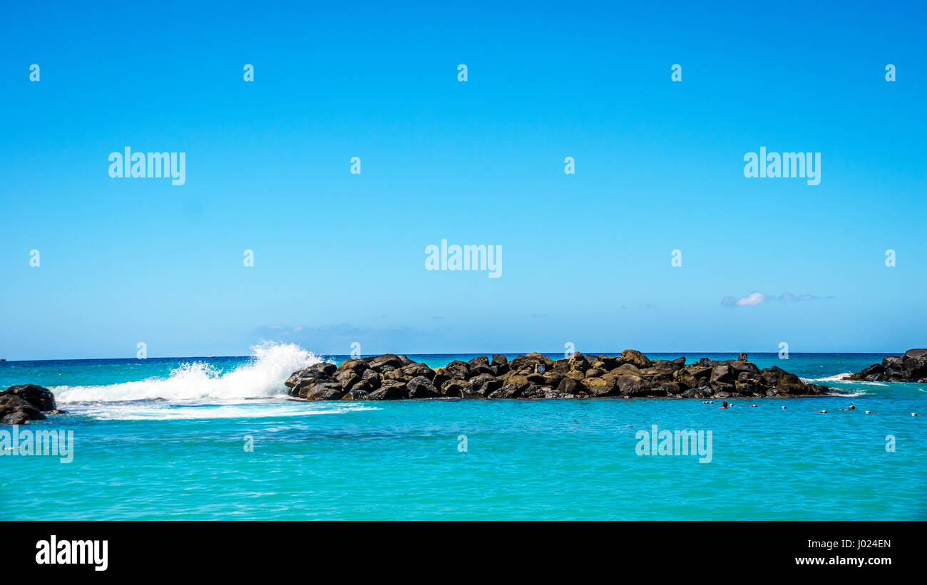 Waves of the Pacific Ocean crashing on the rocks of the barriers at the ...