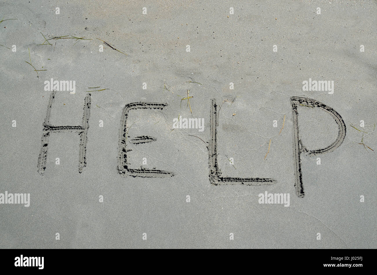 Word “help” written in the sand at the beach Stock Photo - Alamy