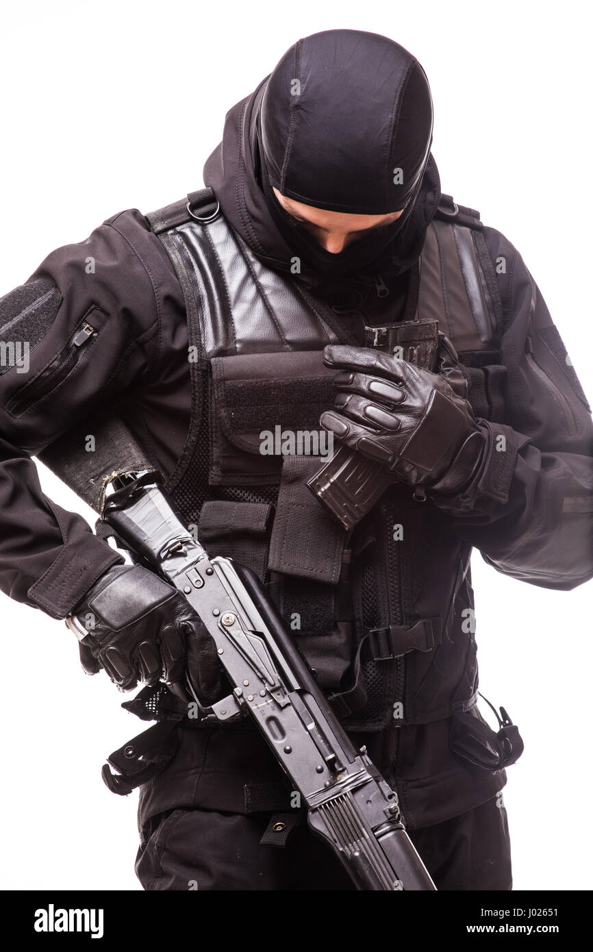 SWAT officer with assault rifle in black uniform isolated on white ...