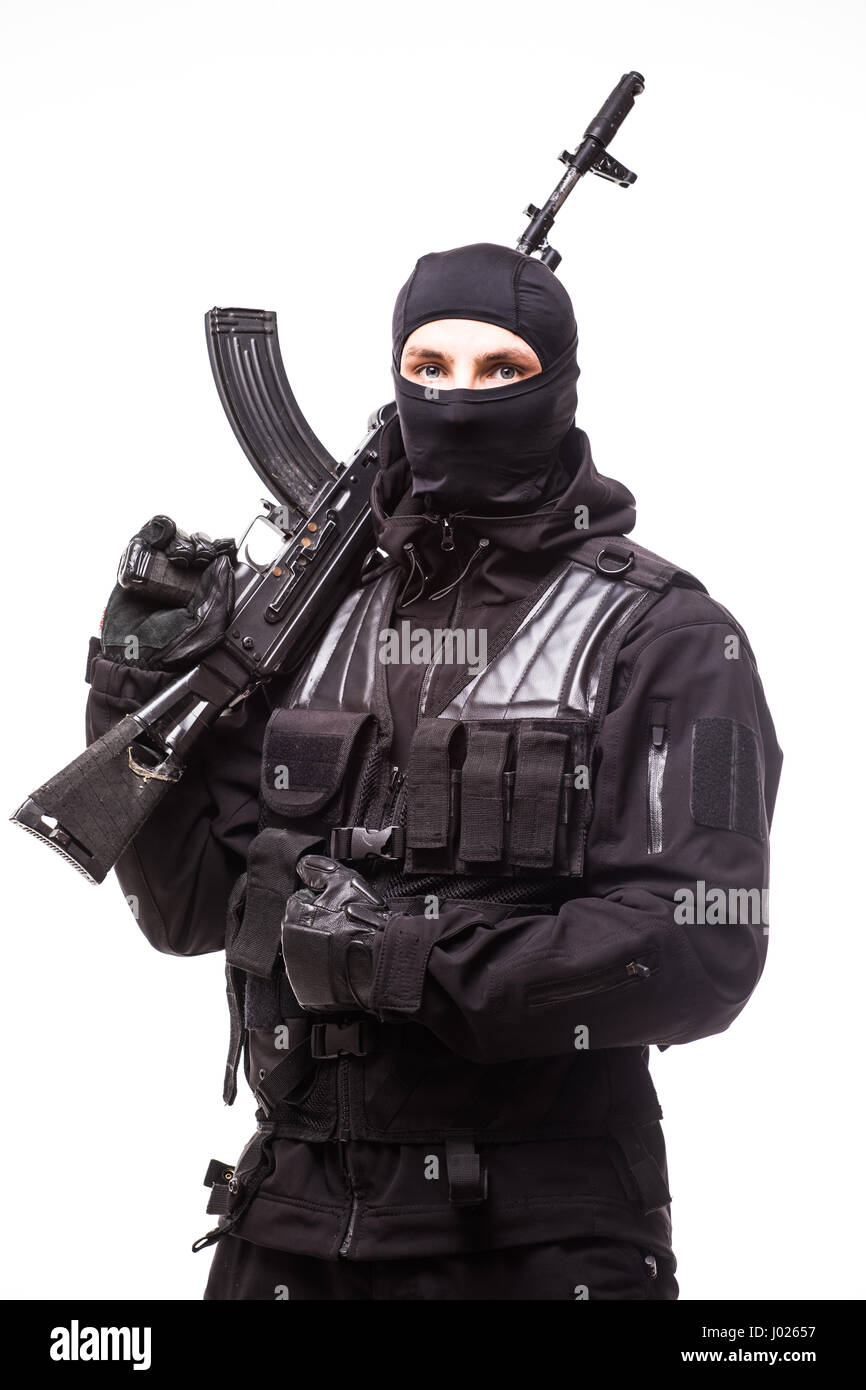 Portrait of dangerous bandit in black wearing balaclava and holding gun ...