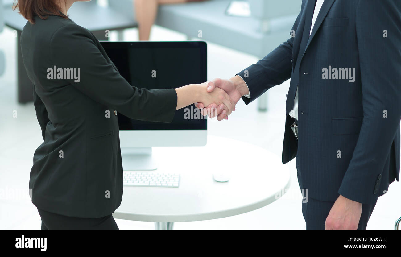 Two business people shaking hands with each other in the office Stock ...