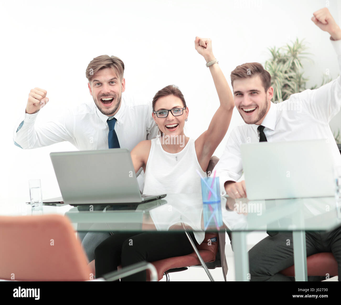 Picture of happy business team celebrating victory in office Stock ...