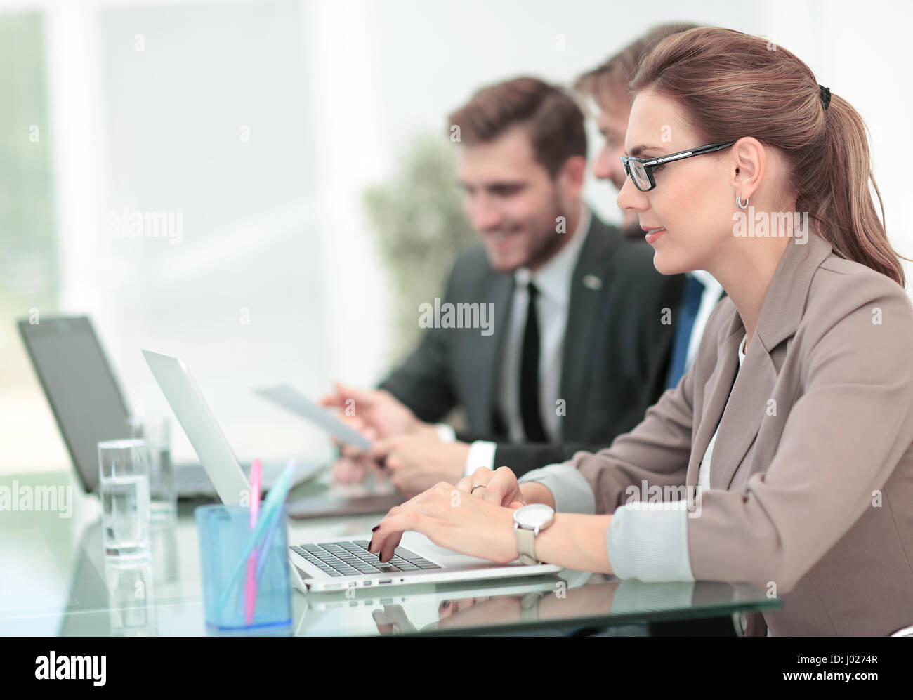 Business people working around table in modern office Stock Photo - Alamy