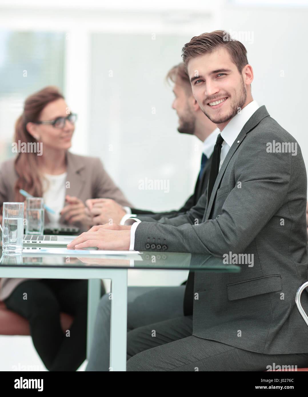 Business people working around table in modern office Stock Photo - Alamy