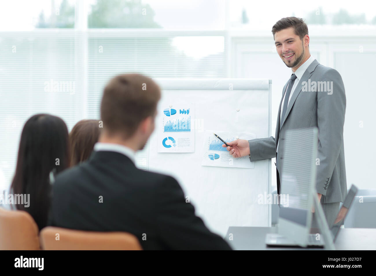 Business man asking question during his colleagues presentation Stock ...