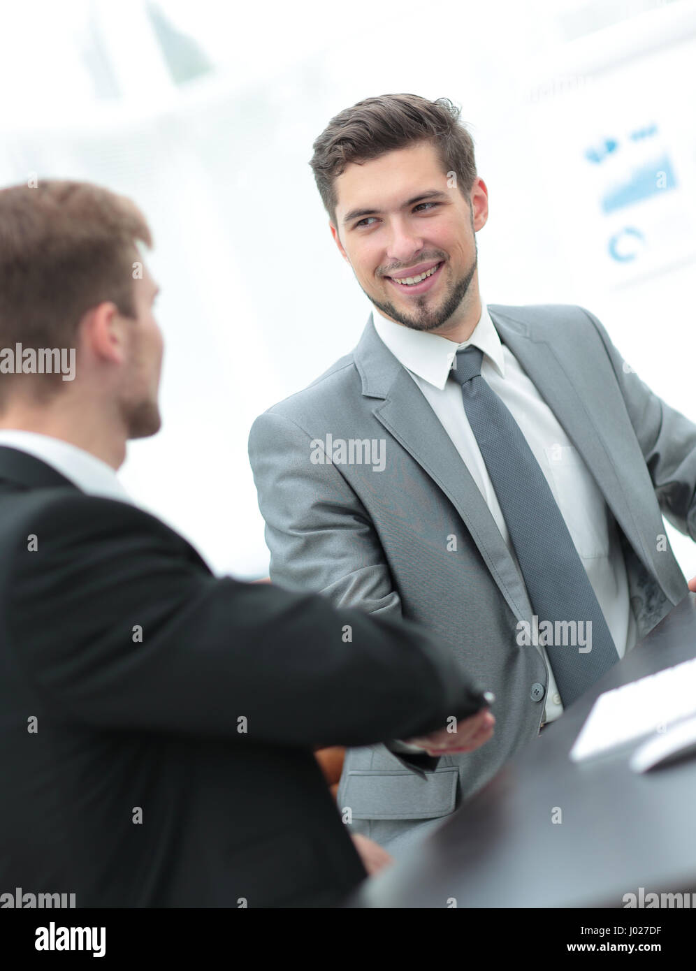 Two successful business men discussing documents in a modern off Stock ...