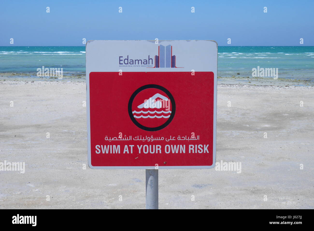 Warning sign in Arabic and English: swim at your own risk, Al Jazayer ...