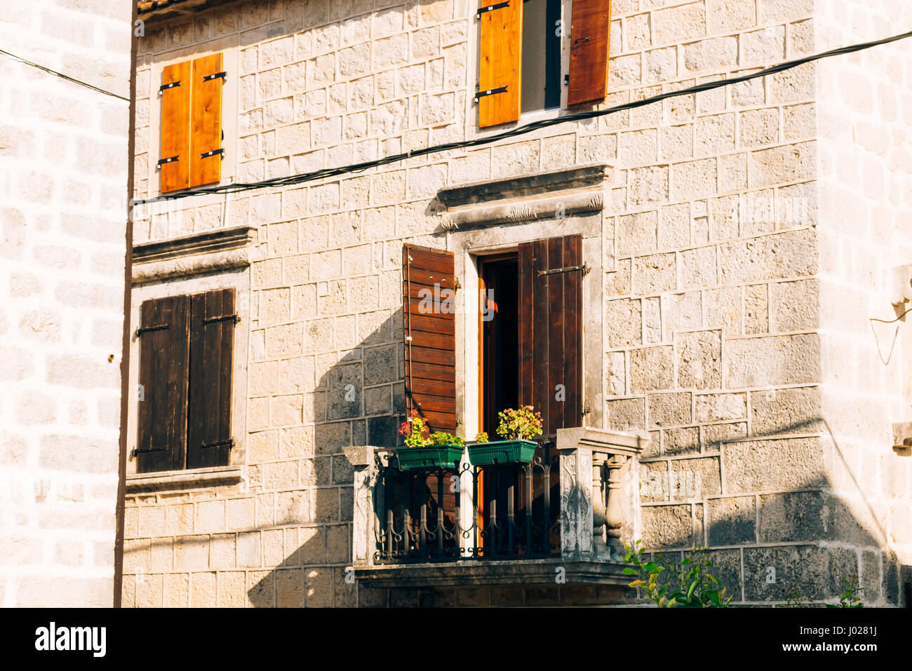 Balcony with columns in an old house. Balkan architecture. Montenegrin ...