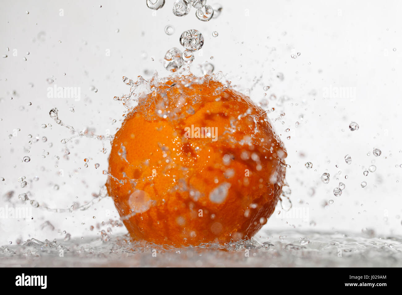 Orange and splashing water Stock Photo - Alamy