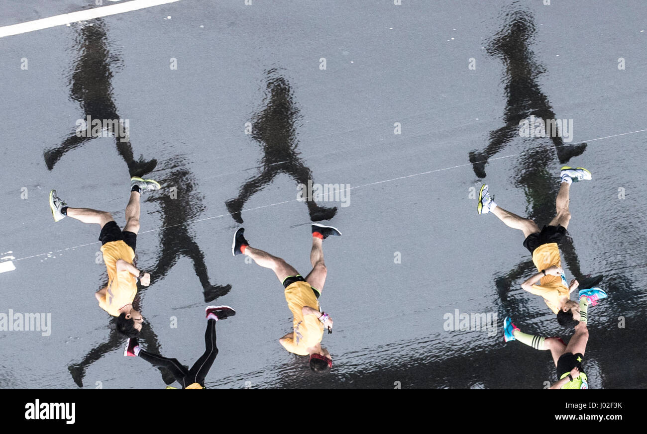 Wuhan. 9th Apr, 2017. Photo rotated 180 degrees shows runners compete ...