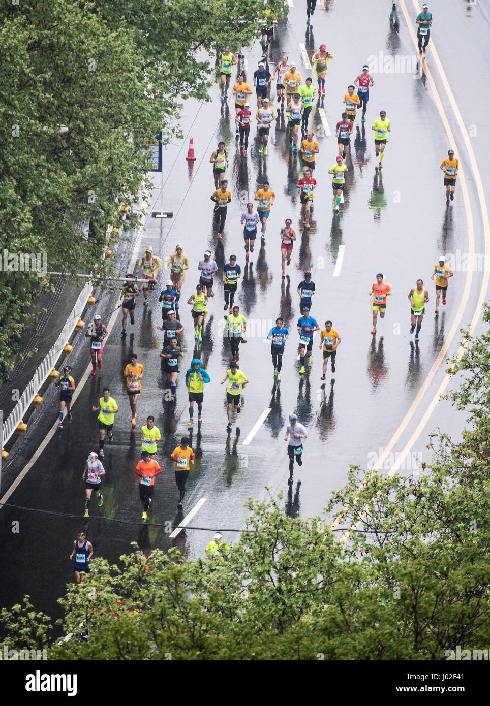 Wuhan. 9th Apr, 2017. Runners compete in the rain during 2017 Wuhan ...
