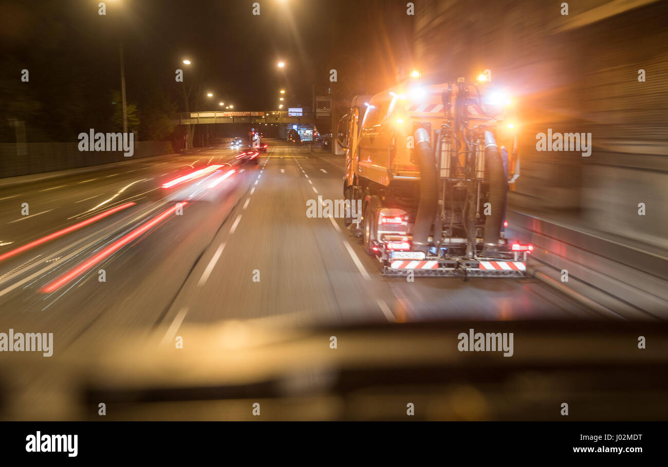 A street cleaning vehicle fitted with special equipment drives through ...