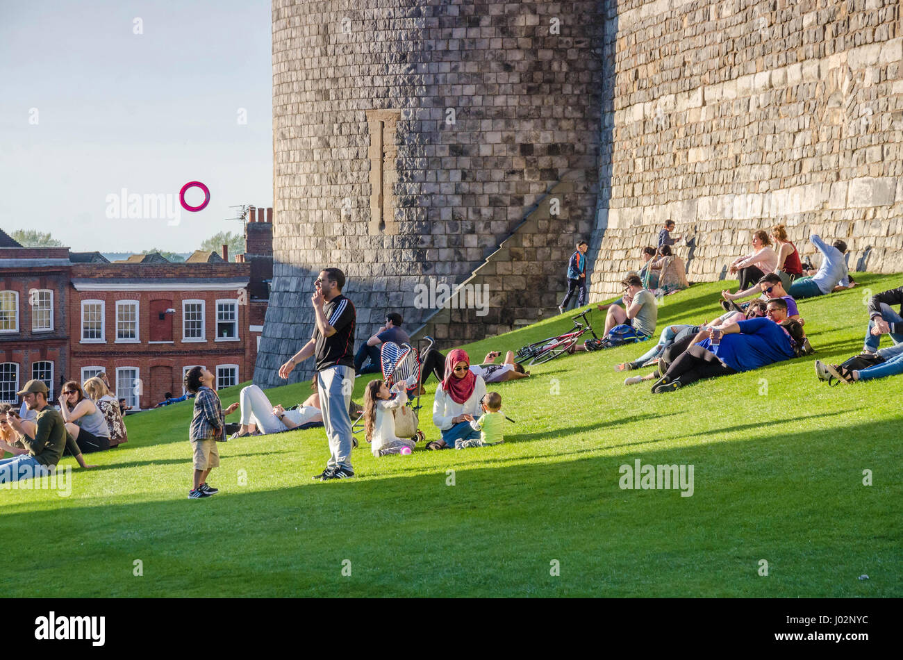 UK Weather: People enjoy the evening sunshine outside Windsor Castle ...