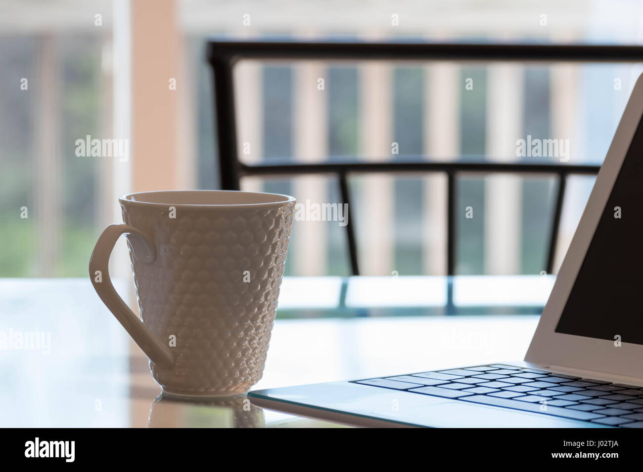 Morning coffee while checking emails Stock Photo - Alamy