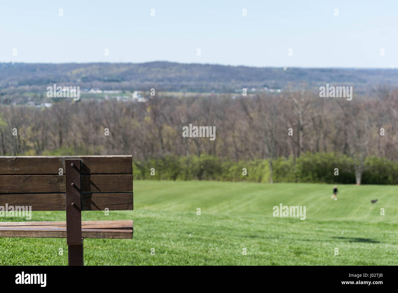Sitting on a park bench enjoying the scenery Stock Photo - Alamy