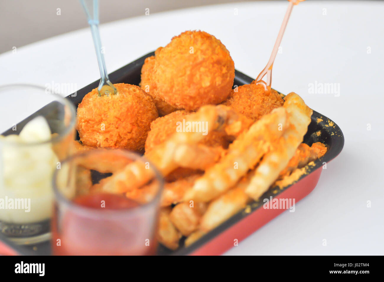 cheese ball and French fries with paprika topping dish Stock Photo - Alamy