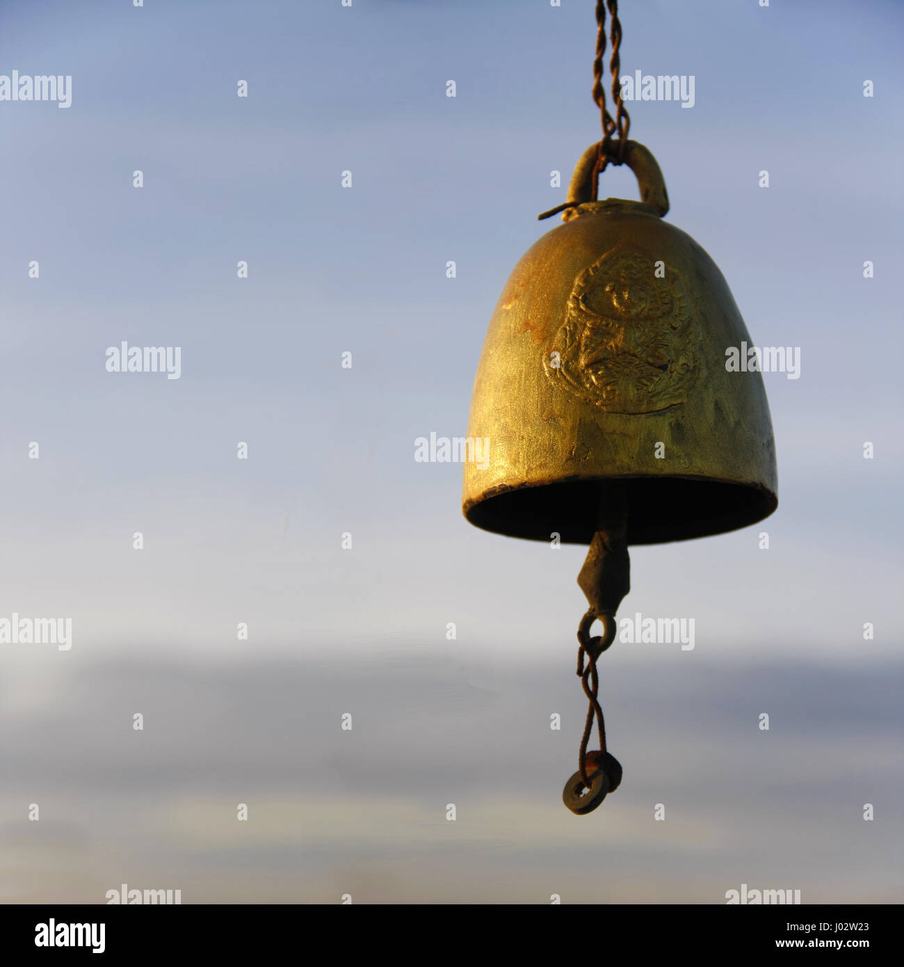 old golden bell hung in the air with reflex of sunshine on morning ...