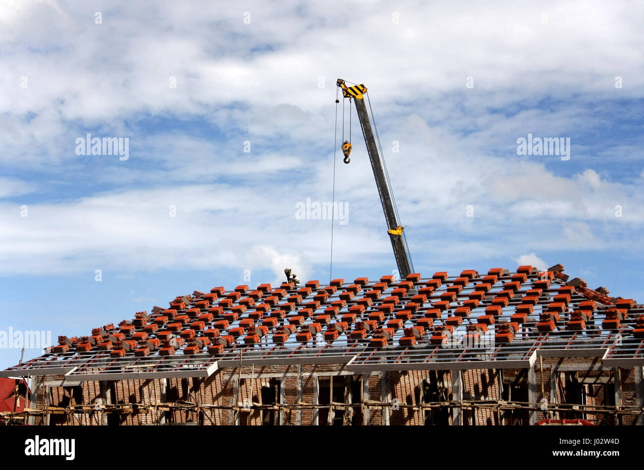 Preparation red tile on roof structure for roofing Stock Photo - Alamy