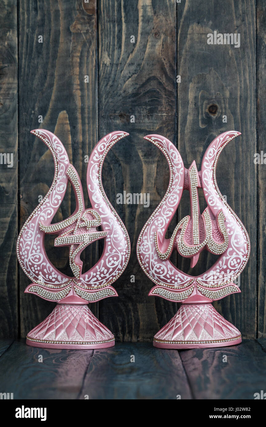 Pink Religious statuettes with the names of Allah and Muhammed written ...