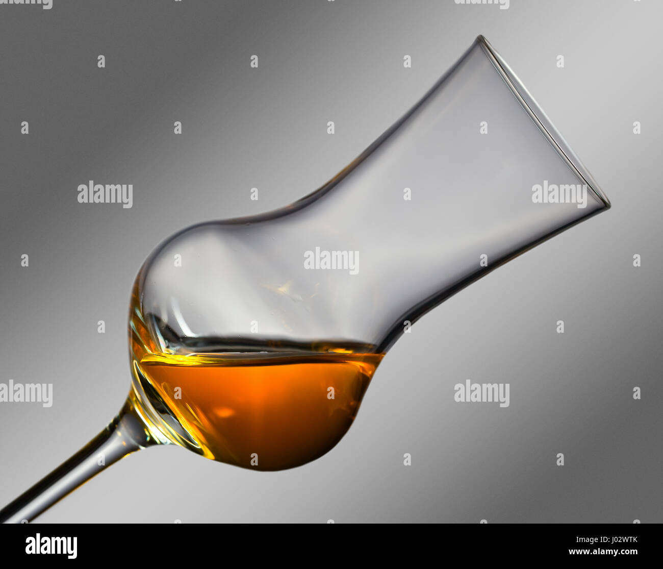 Closeup of glass of alcoholic drink . Macro shot . Neutral grey ...