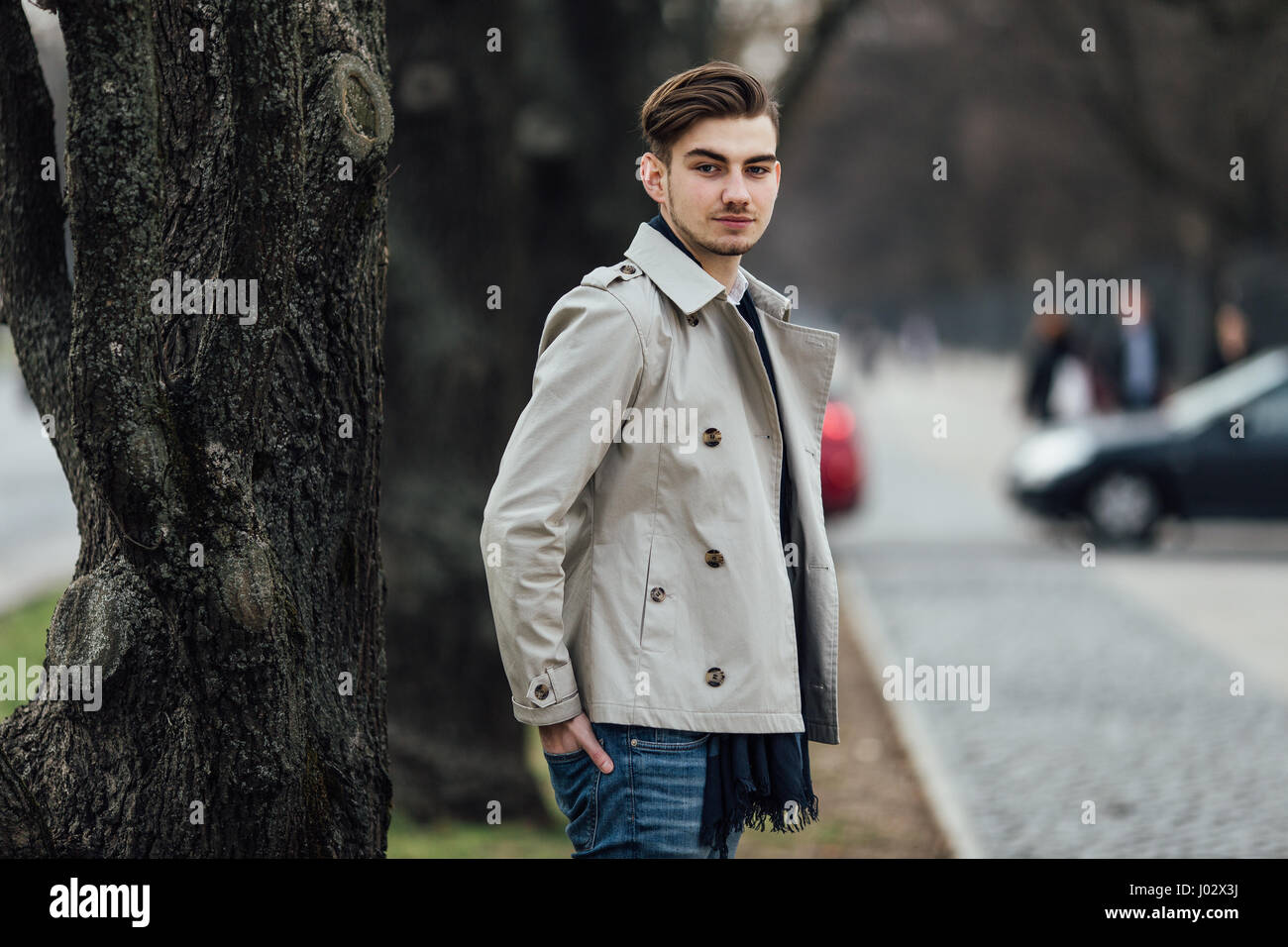 Fashionable man standing outdoors with white background Stock Photo - Alamy
