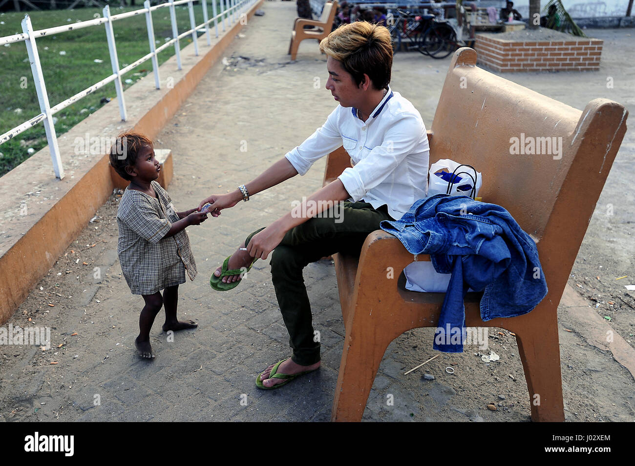 06.05.2014, Yangon, Myanmar, Asia - A shabby looking street child begs ...