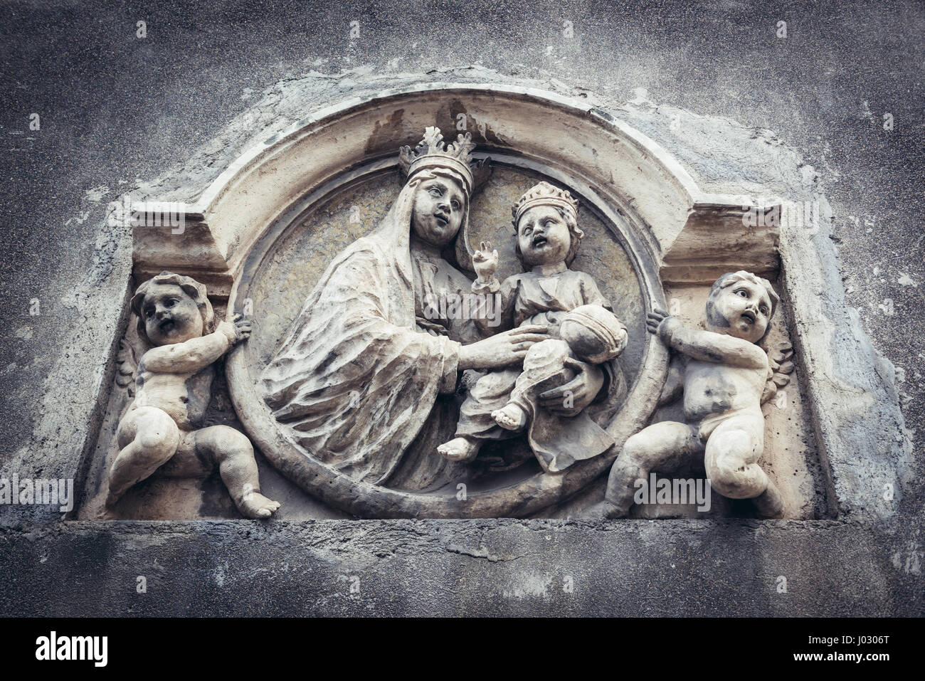 Bas relief of Our Lady and baby Jesus on the wall of Roman Catholic ...
