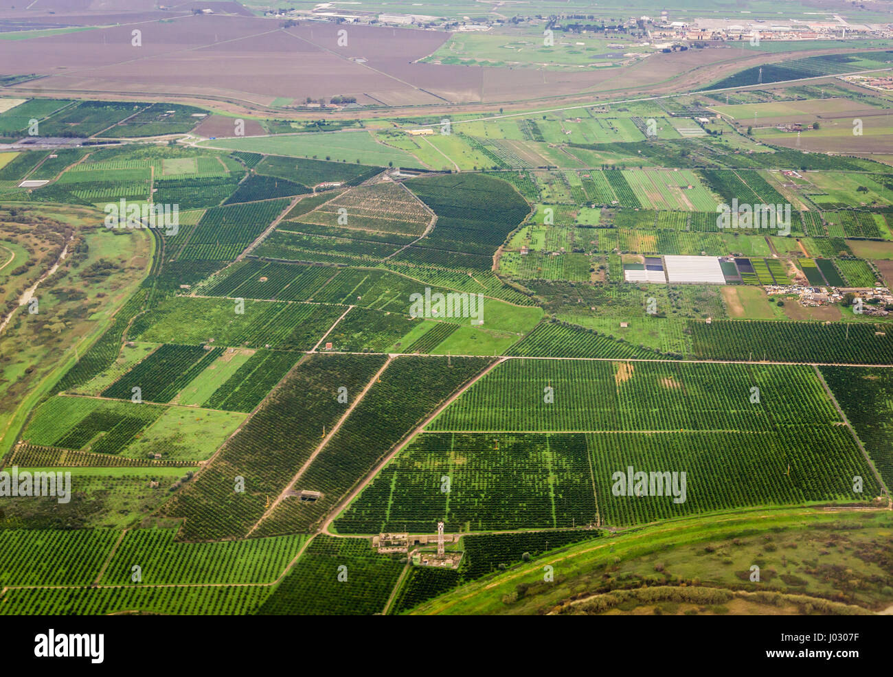 Aerial view from plane window on green fields, near Catania on Sicily ...