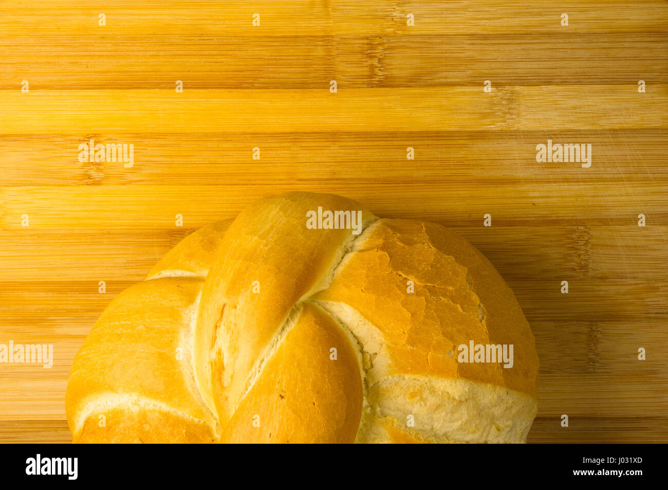 fresh braided loaf of white wheat bread on bamboo wooden background ...