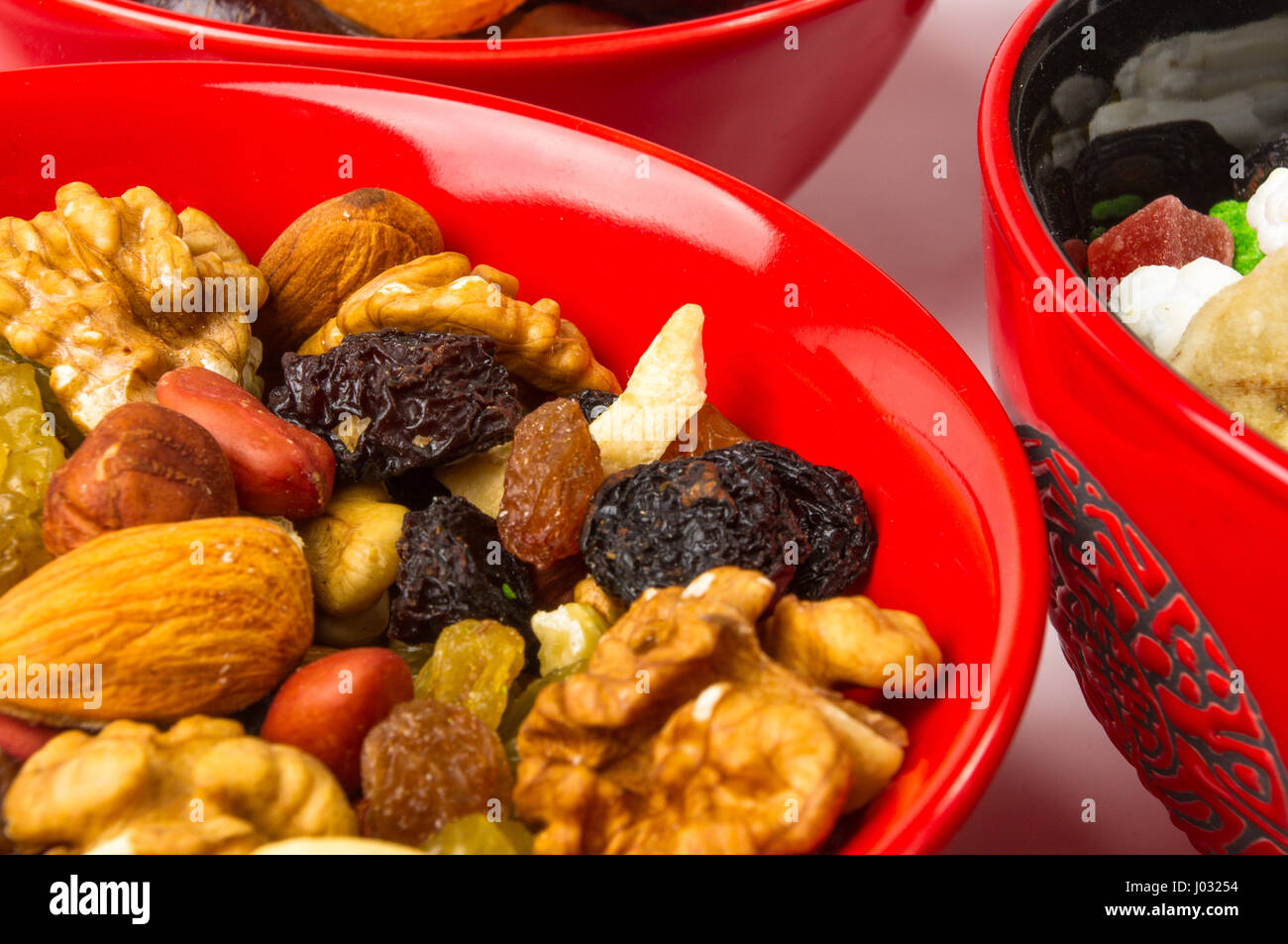 various dried fruits, mixed nuts and walnuts on the white background ...