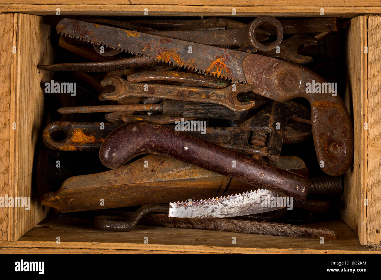 old rusty tools in a box on wooden background Stock Photo - Alamy