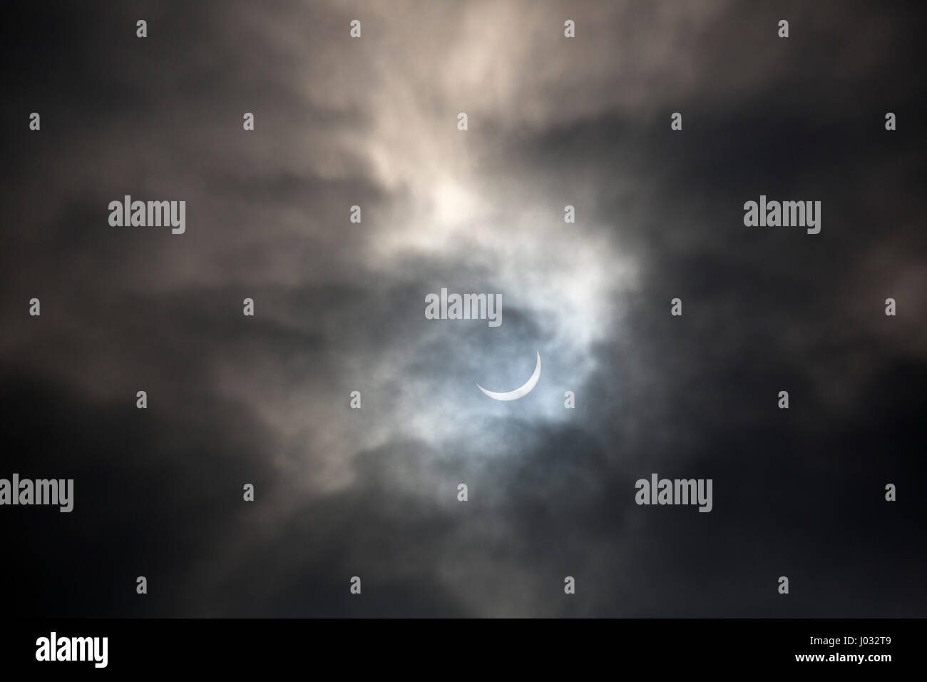 Solar eclipse with the Sun partially covered by the Moon and surrounded ...