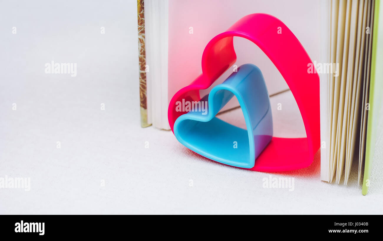 Blue and red hearts inside an open diary book Stock Photo - Alamy