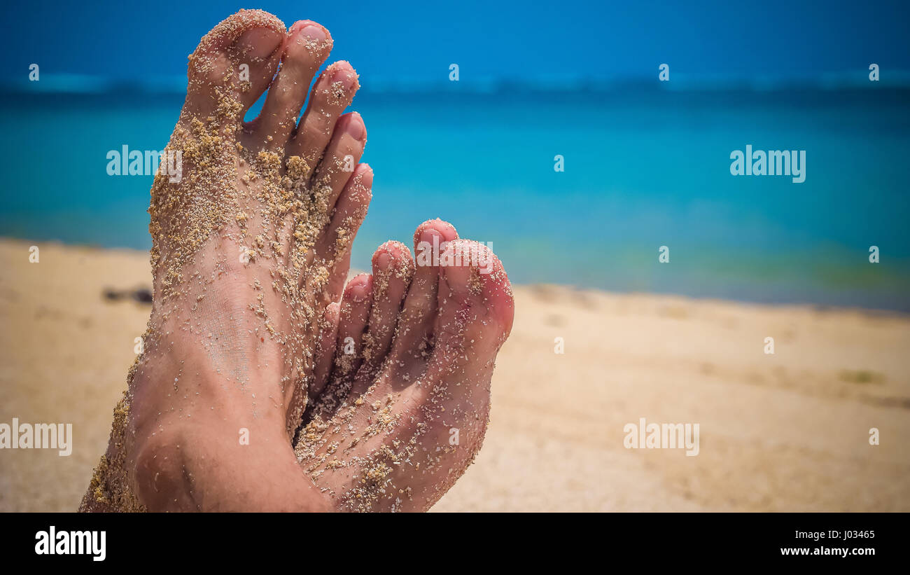 Male Cross Feet at the Sandy Beach, Ocean in Background, Bali Stock ...