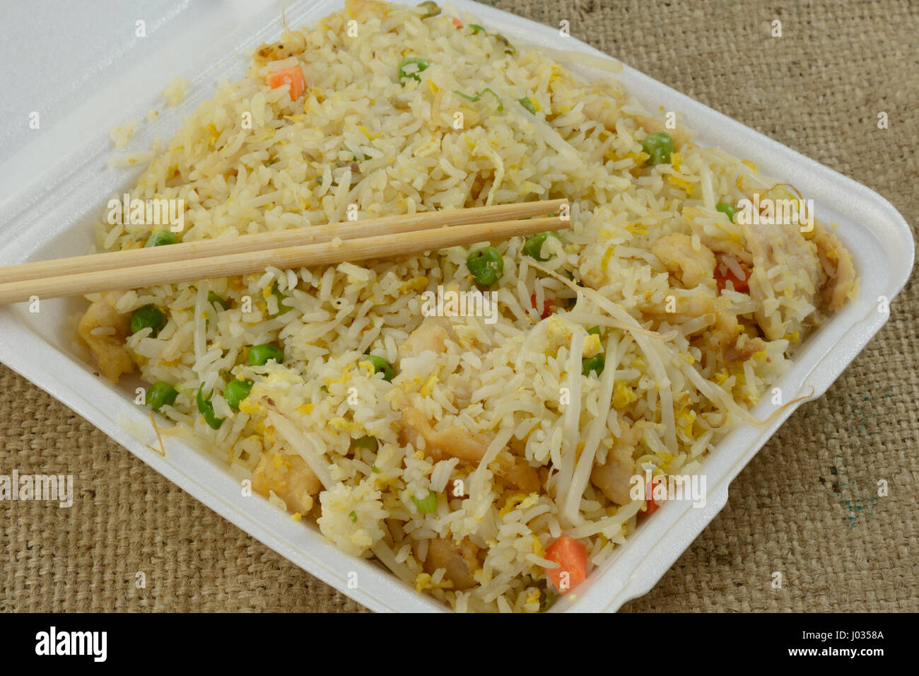 Chinese food take out of steamed fried rice with chicken, egg and ...
